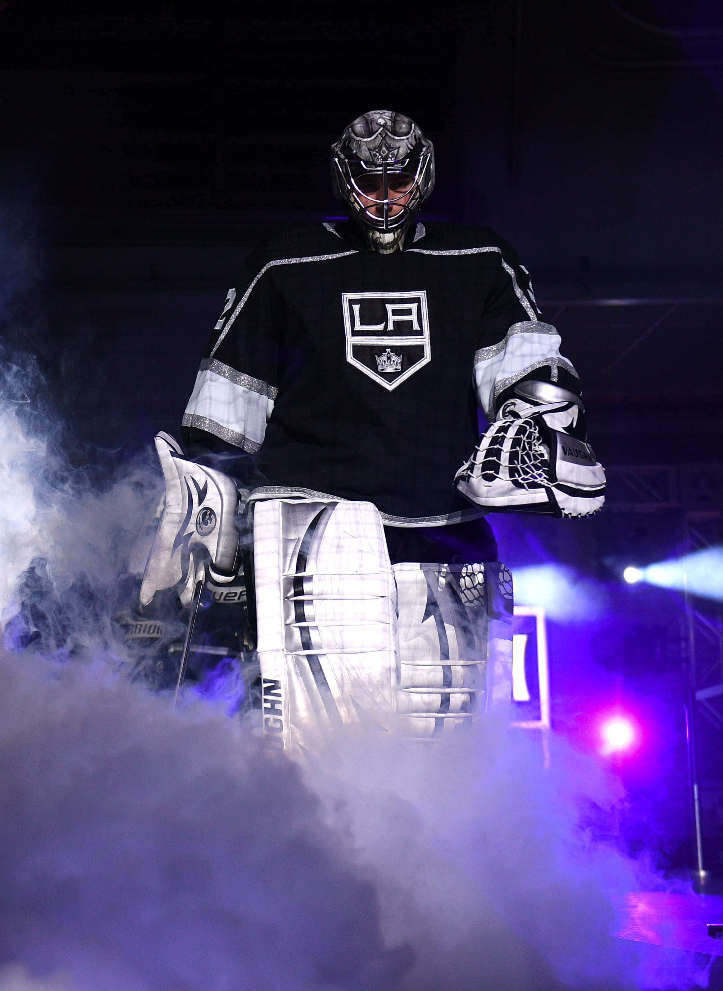 Download A Hockey Goalie Standing In Smoke Wallpaper | Wallpapers.com