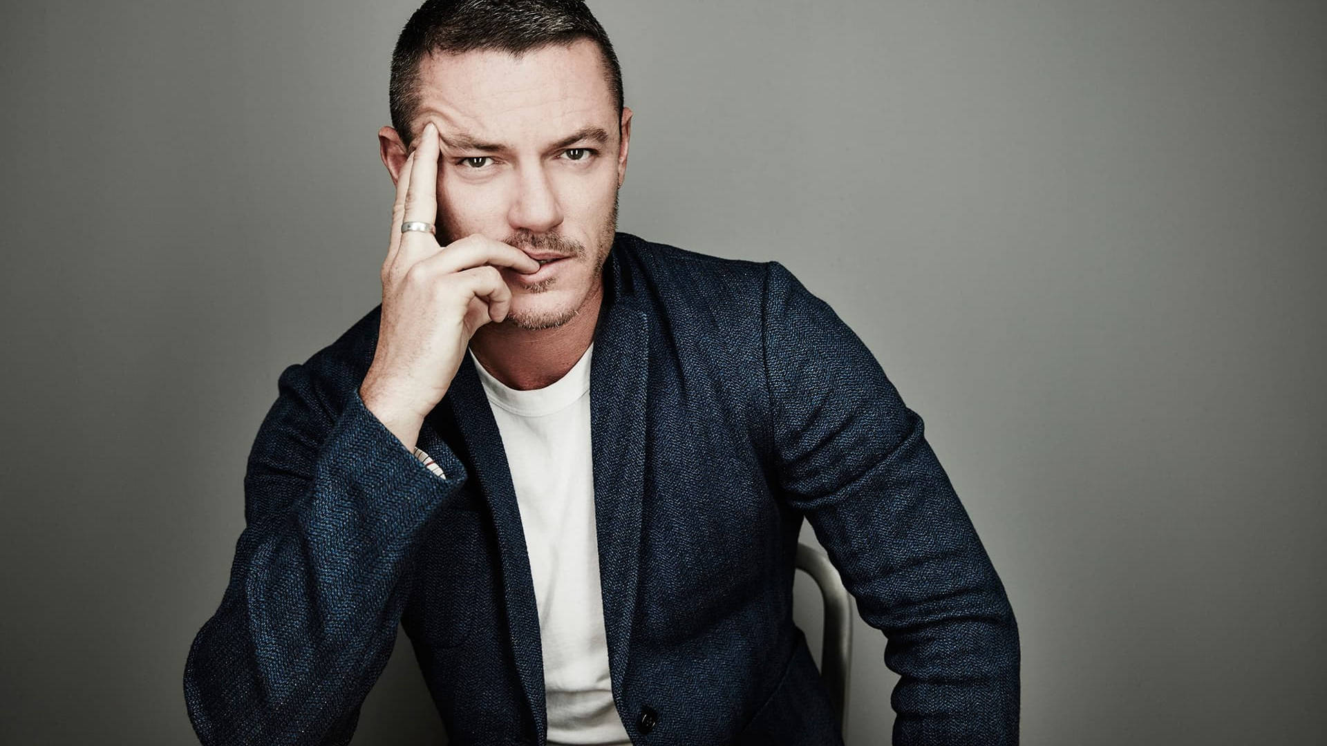 Download Luke Evans Thinking Pose Wallpaper | Wallpapers.com