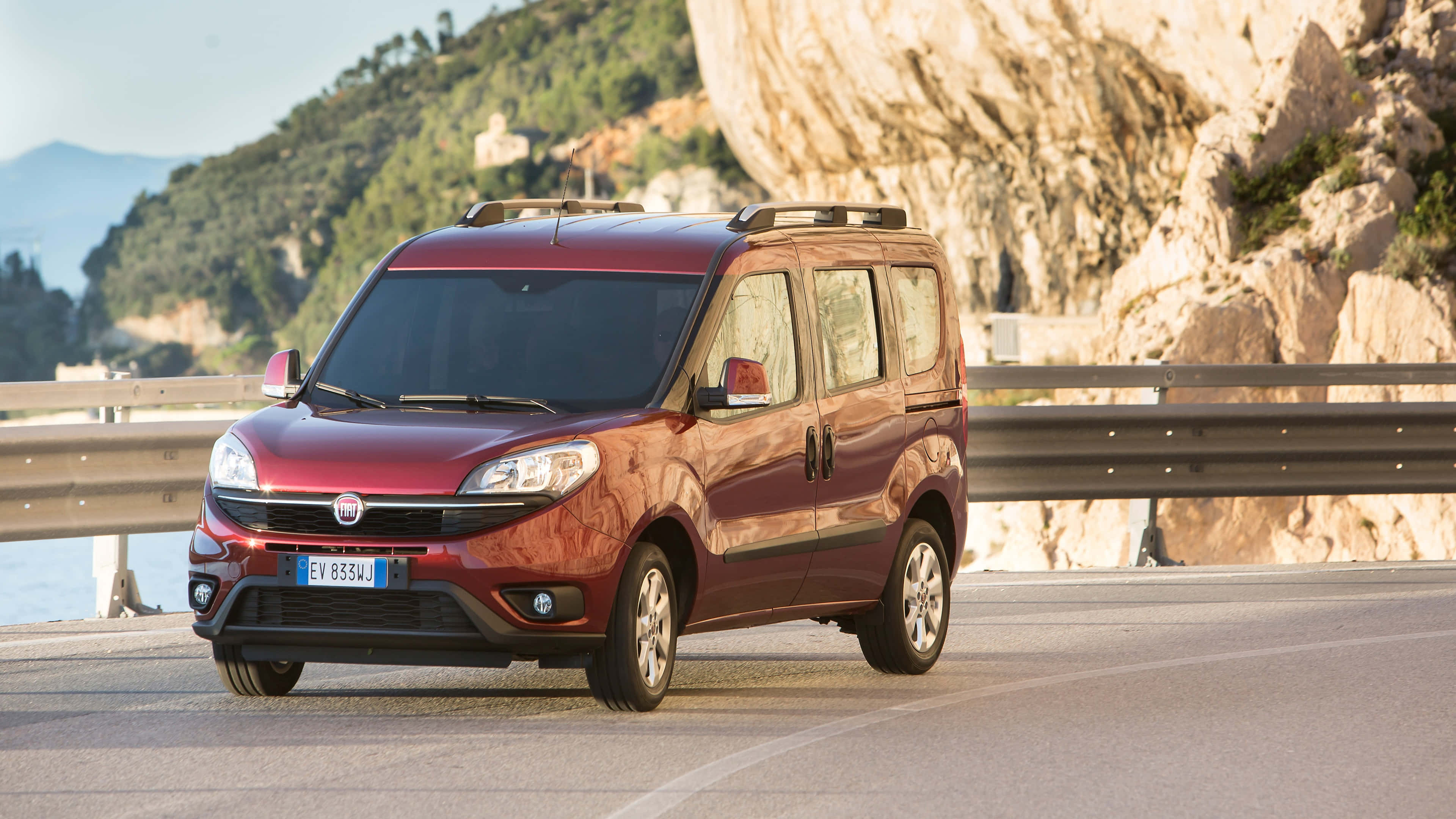 Download Sleek And Spacious Fiat Doblo On The Go Wallpaper | Wallpapers.com