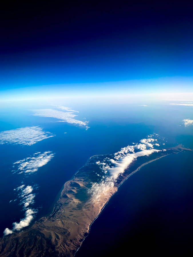 Download Island From Space Top Iphone Wallpaper | Wallpapers.com